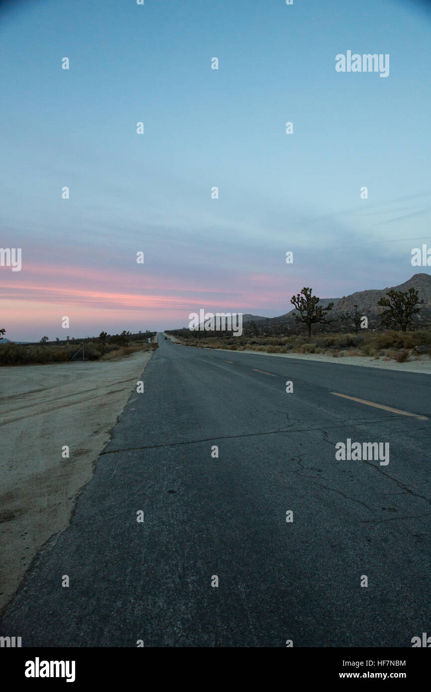 A road in the desert at sunset Stock Photo - Alamy