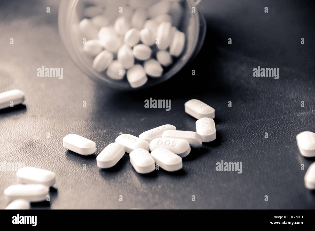 Photograph of some some pills spilled on a table Stock Photo - Alamy