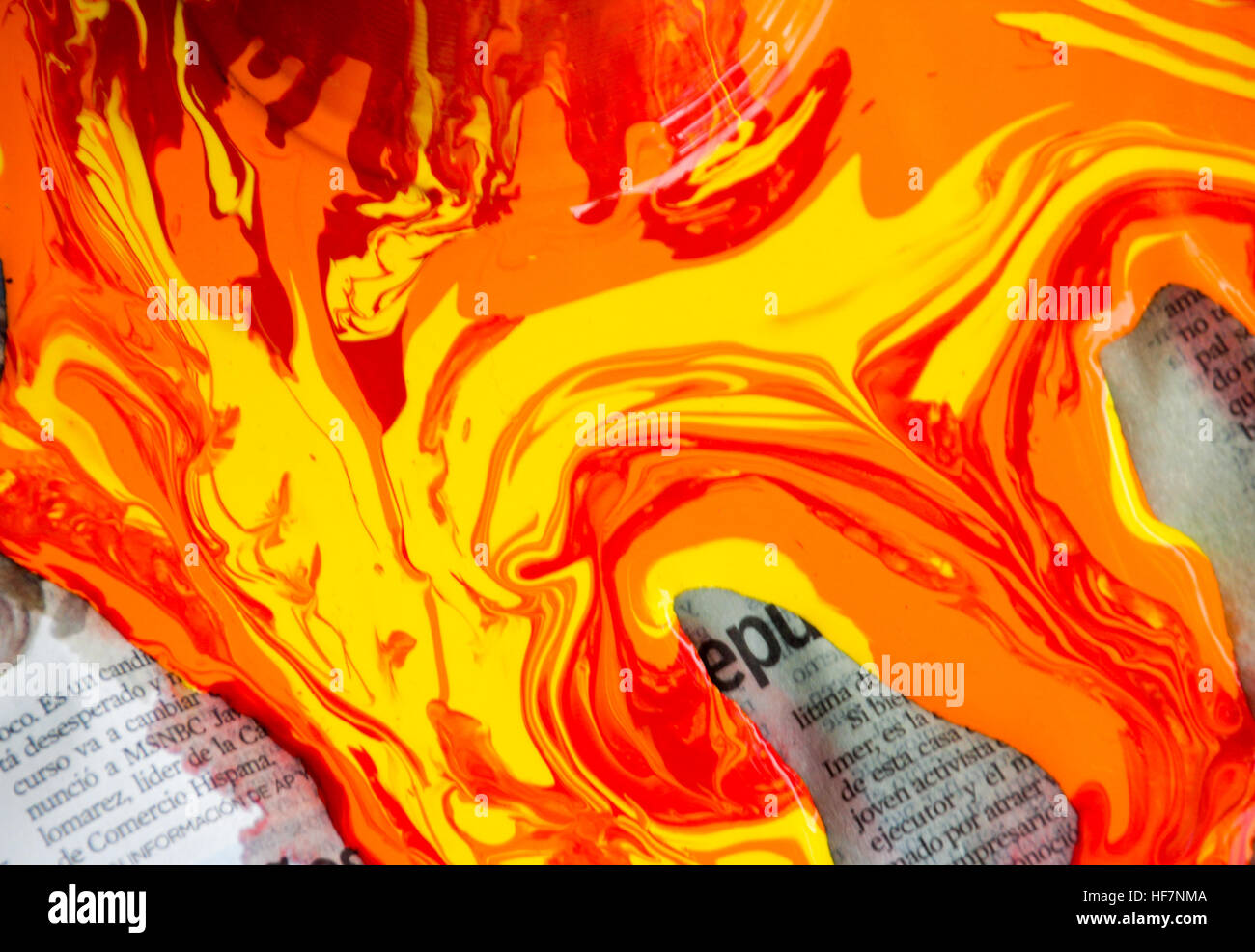 Photograph of some paint pouring out and spilling on a paper Stock ...