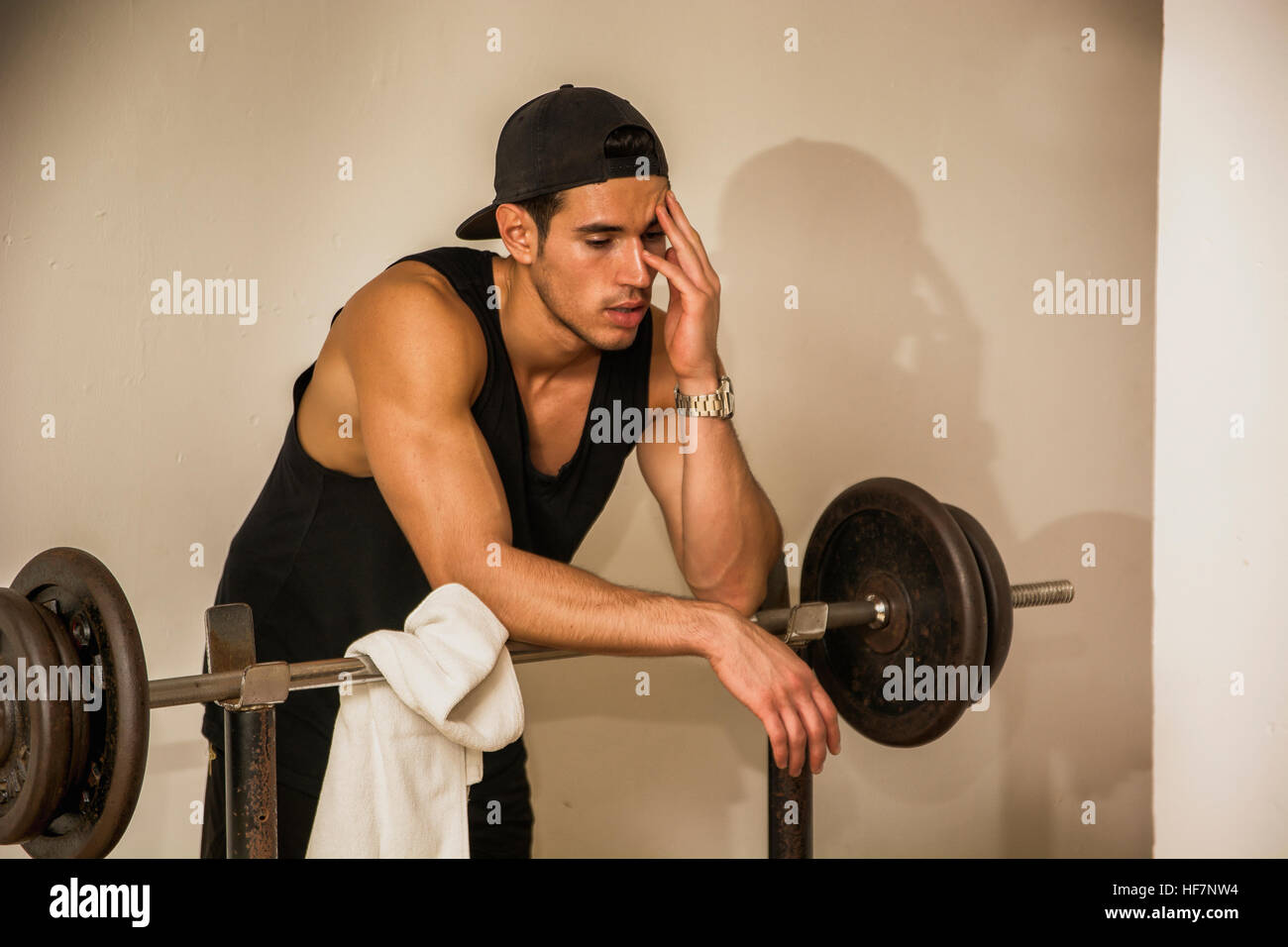 Handsome young man resting after workout in gym Stock Photo - Alamy