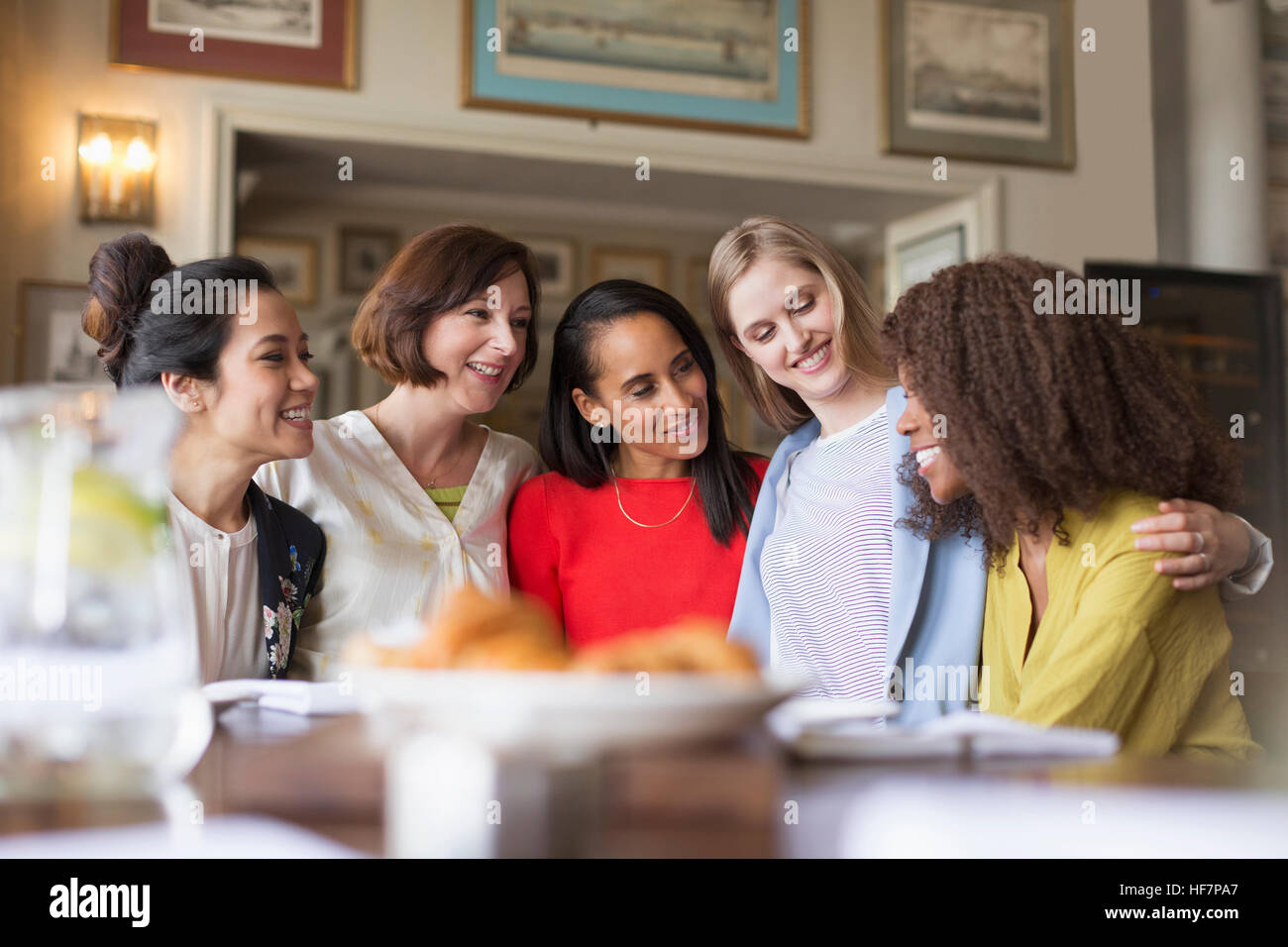 Smiling women dining and talking in restaurant Stock Photo - Alamy
