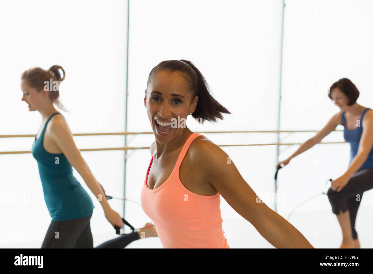 Portrait enthusiastic woman jumping rope in exercise class gym studio ...
