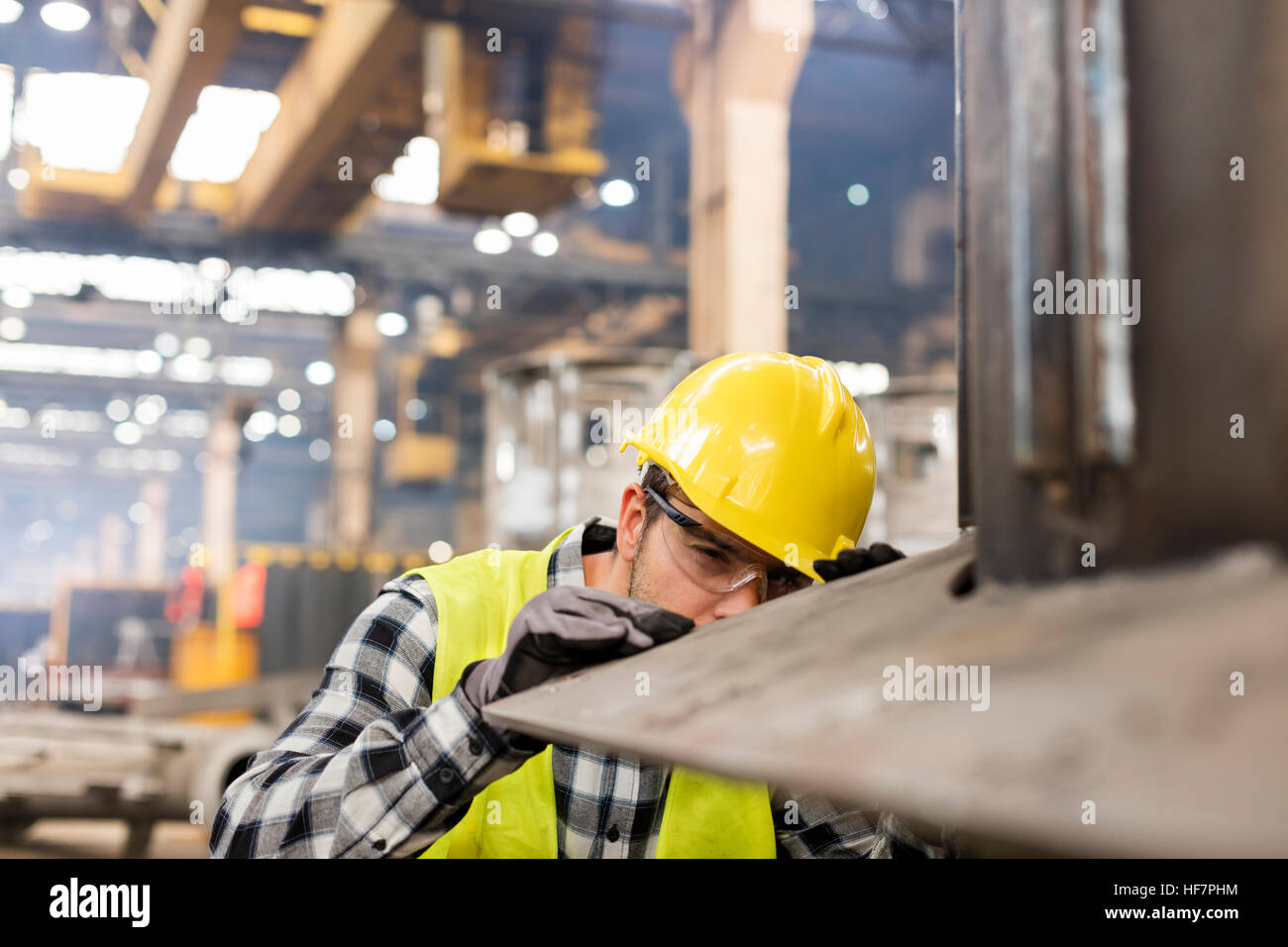Steel worker examining steel in factory Stock Photo - Alamy