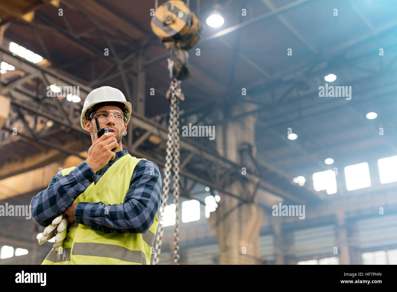 Steel worker with walkie-talkie in factory Stock Photo - Alamy