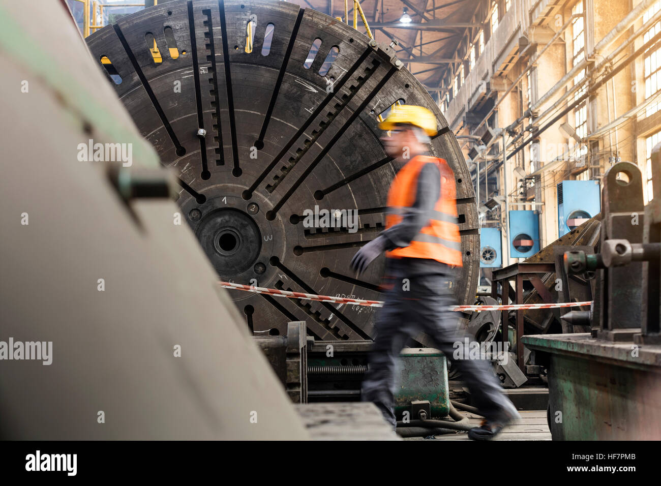 Steel worker walking in factory Stock Photo - Alamy
