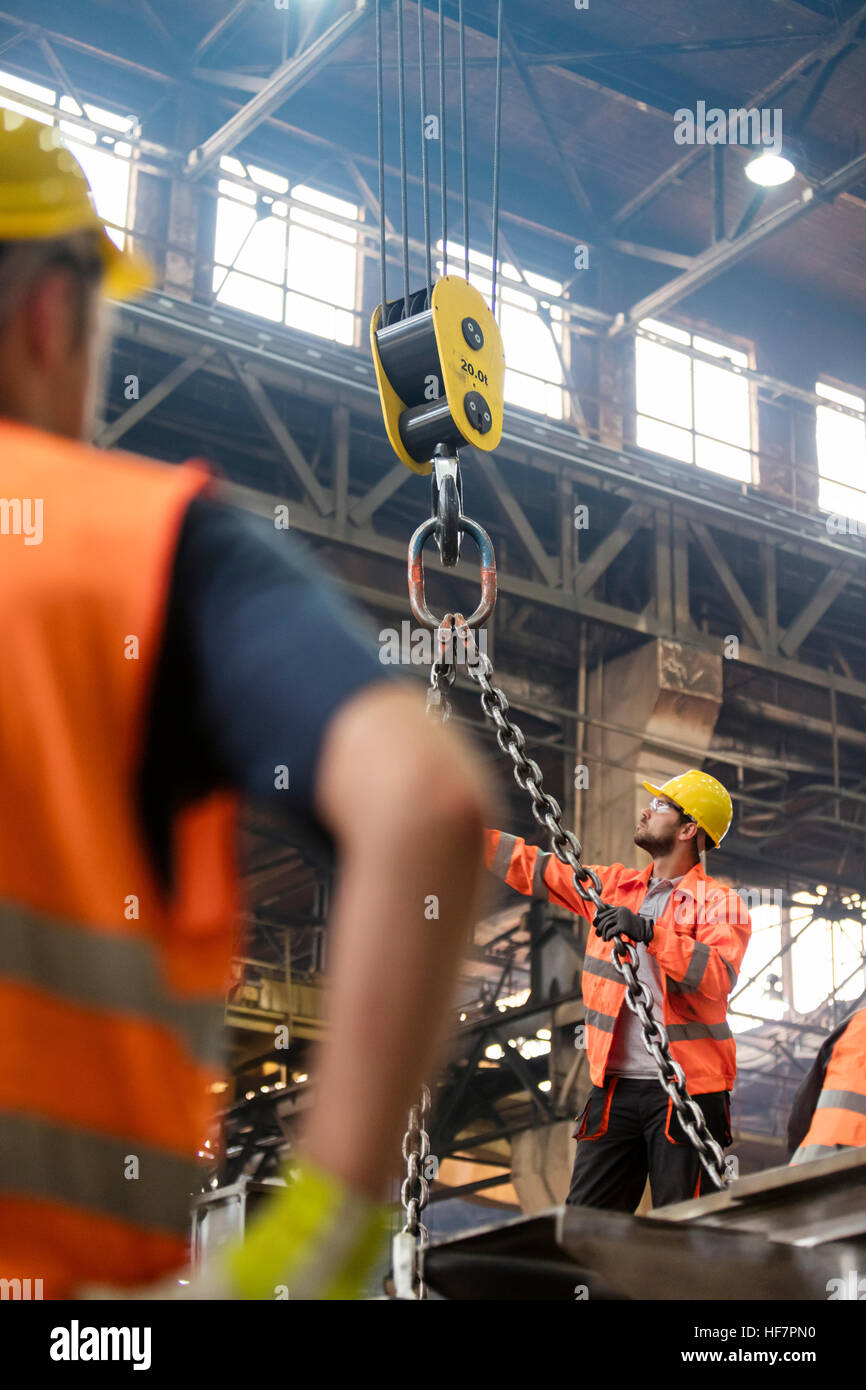 Steel workers operating crane in factory Stock Photo - Alamy