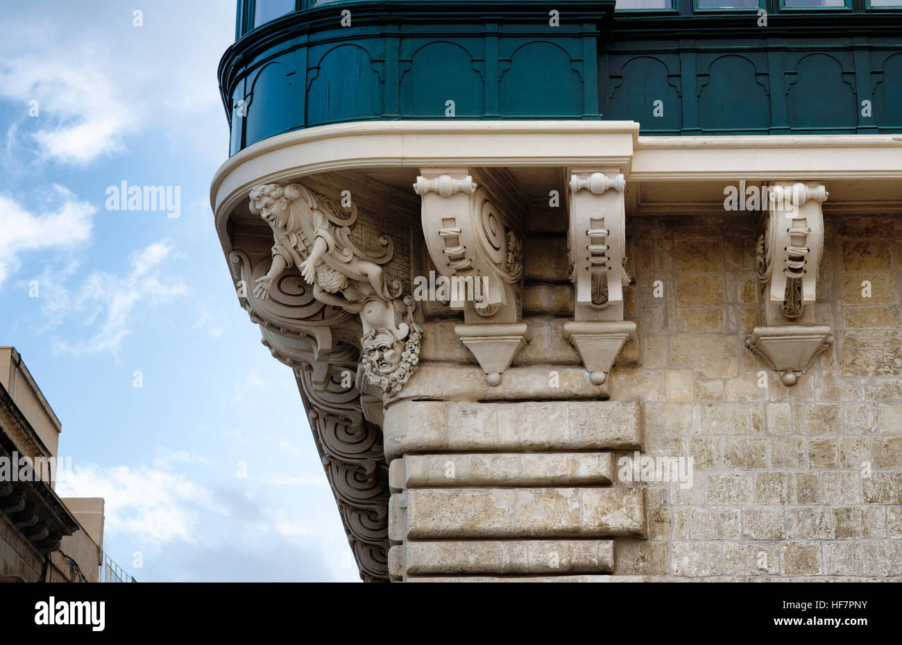 Detail of an old urban building stone facade with tall windows and ...