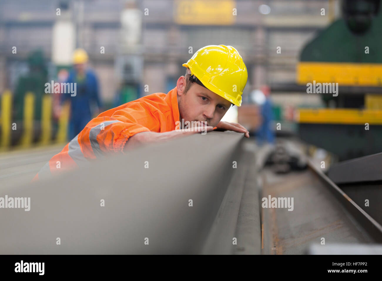 Steel worker examining steel in factory Stock Photo - Alamy