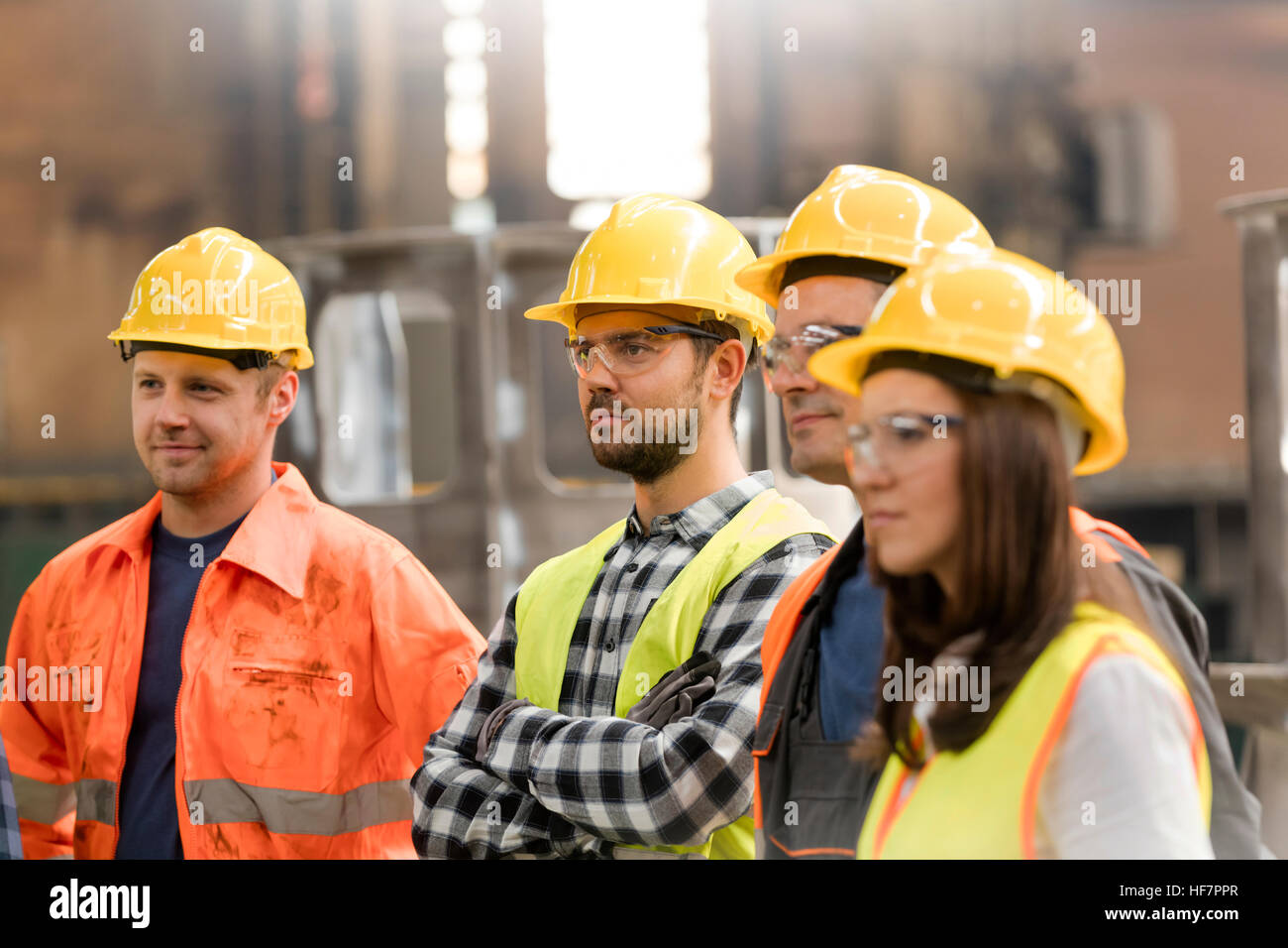 Steel workers listening in meeting in factory Stock Photo - Alamy