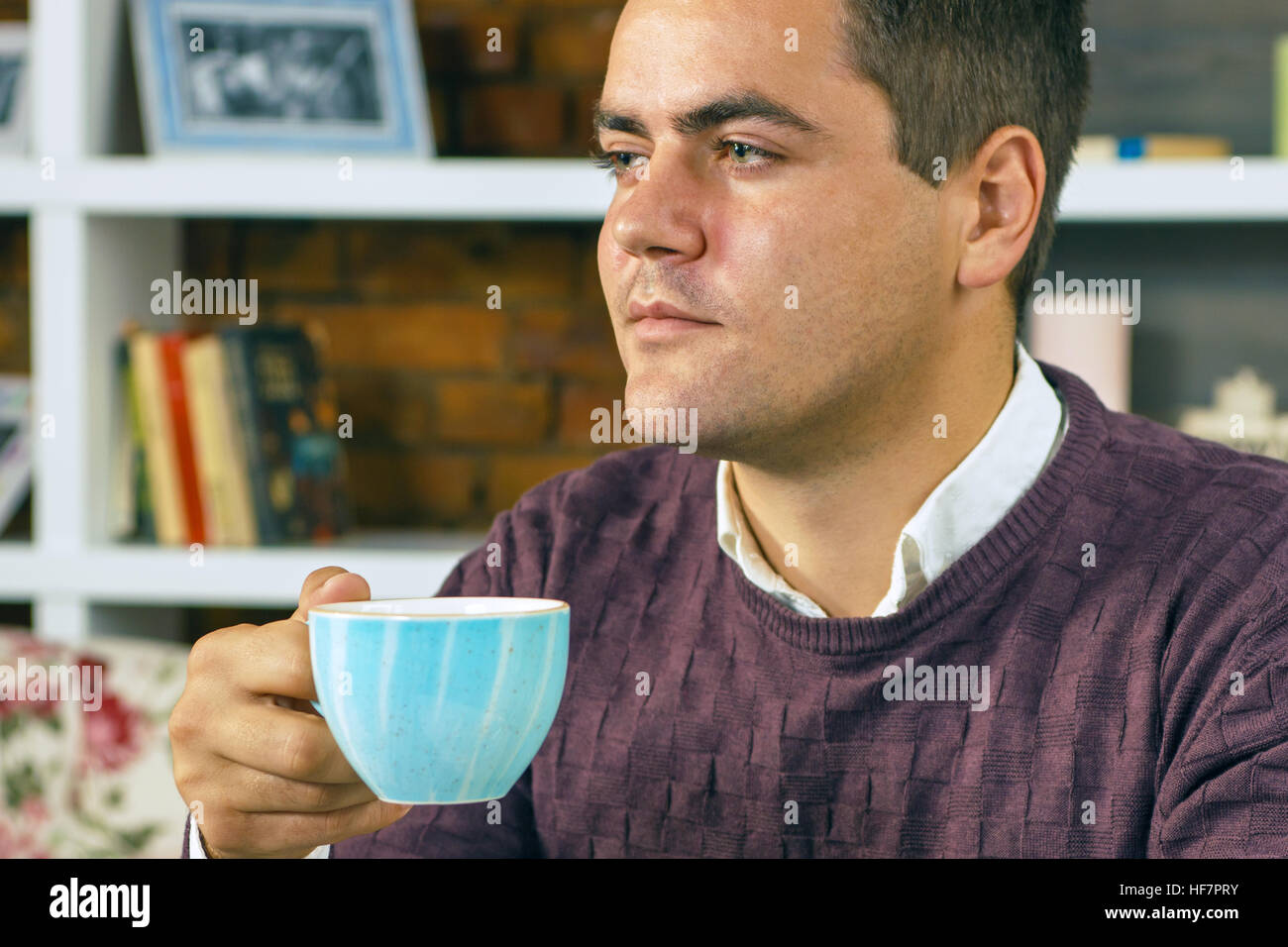 Young man holding a cup in hand and smiling Stock Photo - Alamy
