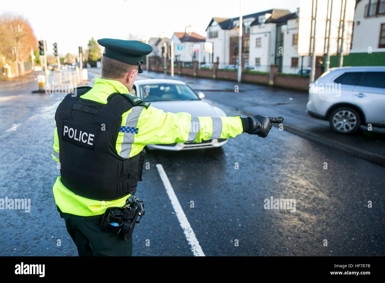 A PSNI Road Policing officer flags down oncoming drivers during a ...