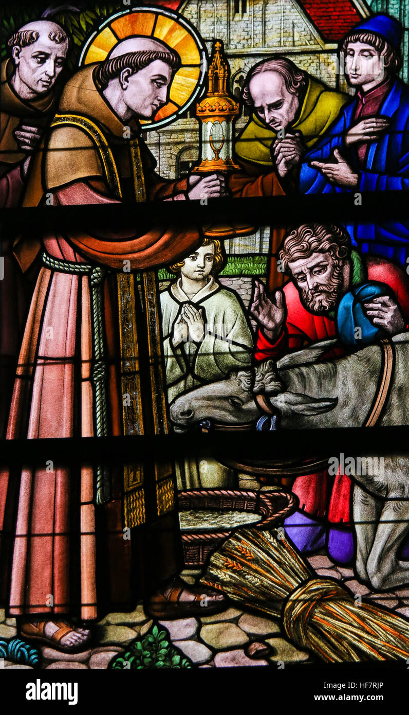 Stained Glass window depicting Saint Anthony of Padua with the kneeling ...