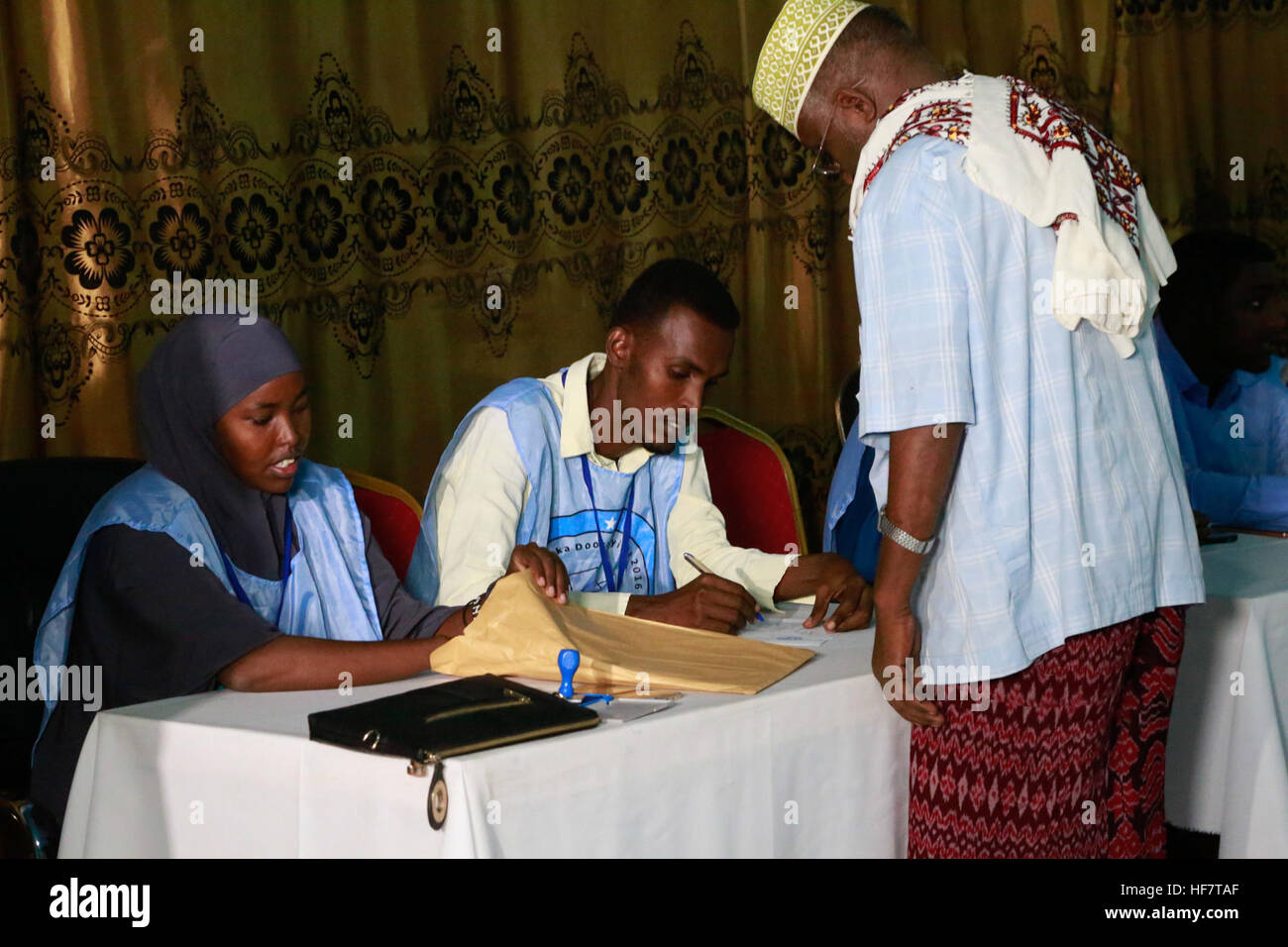Electoral officials register a delegate during the electoral process to ...