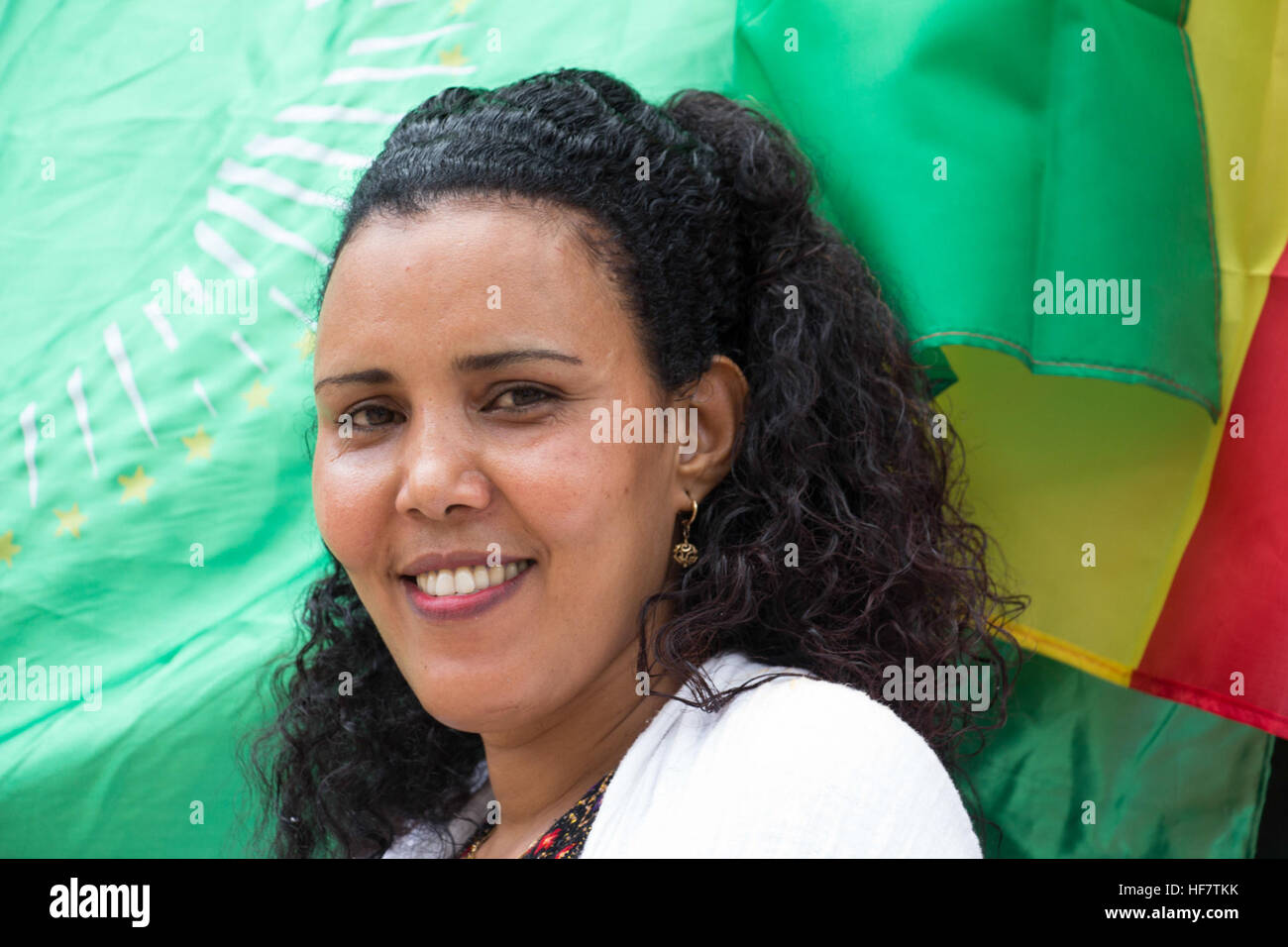 A woman holds the African Union and Ethiopian flags during the ...