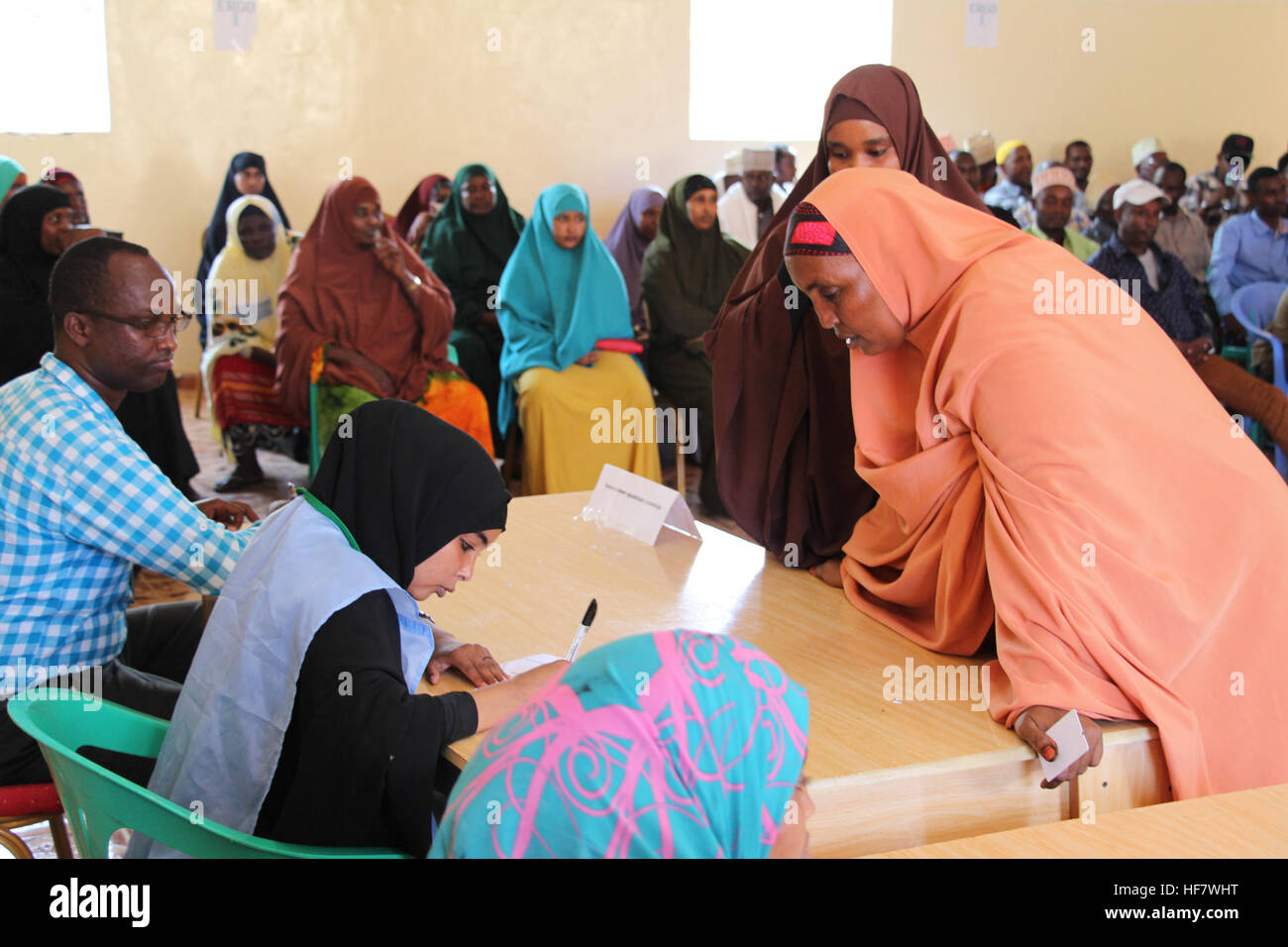 Electoral officials register a delegate during the electoral process ...