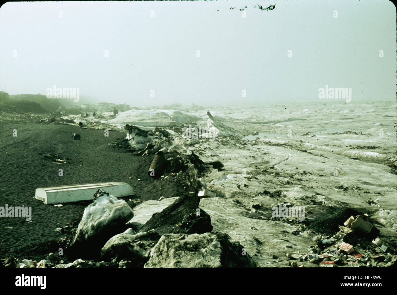 Coastline with small boat at the edge of the Arctic Ocean; Point Barrow ...