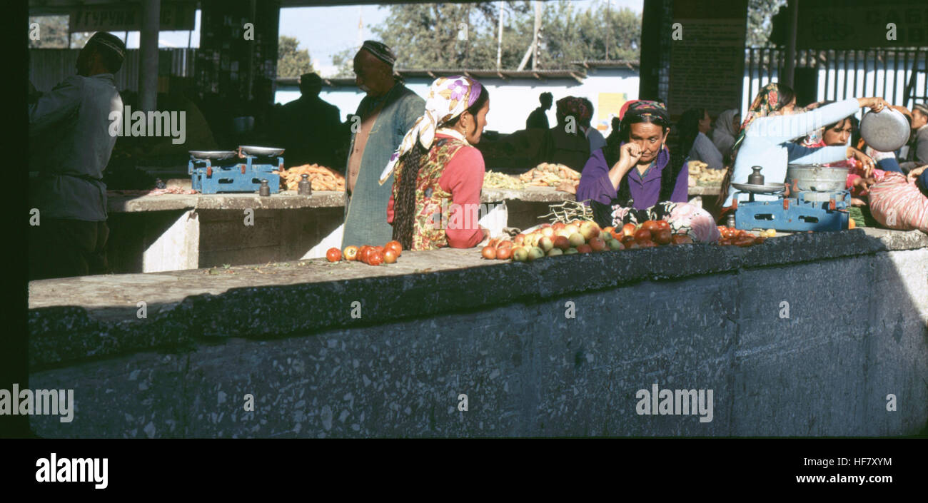 A photograph showing people at a fruit and vegetable stand in Samarkand ...