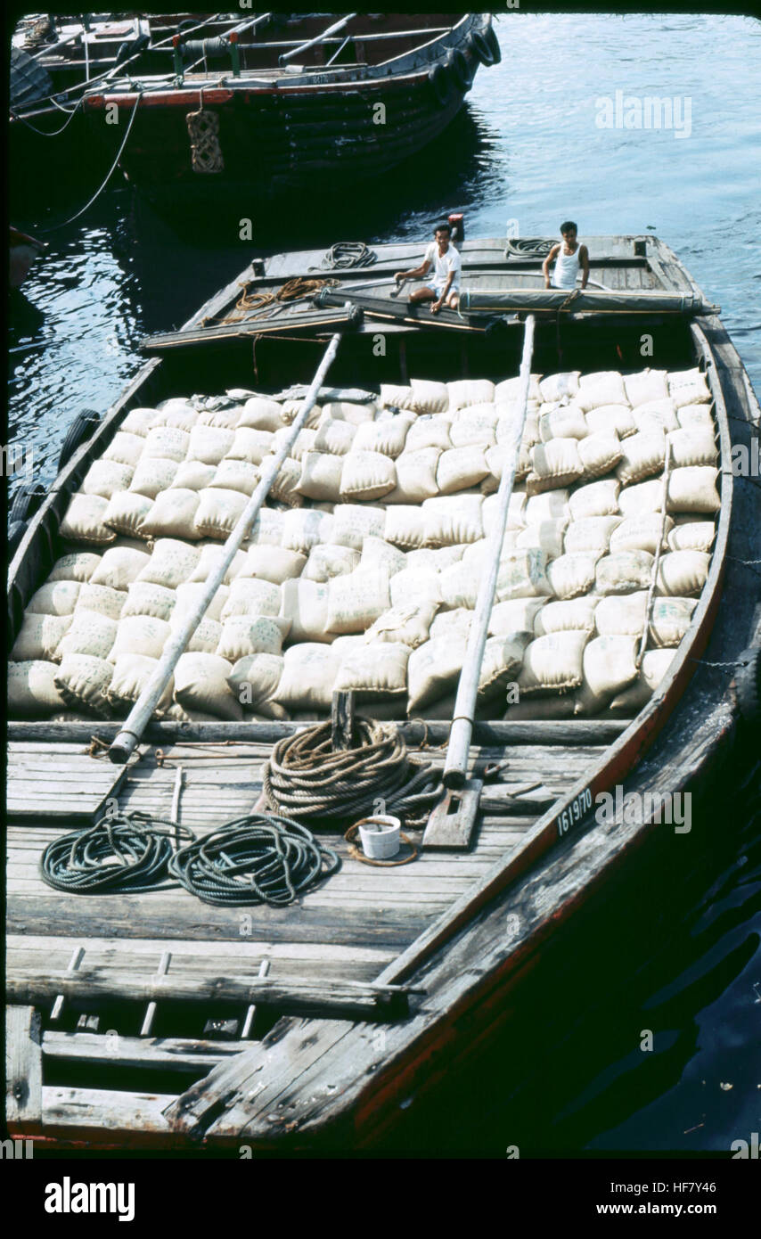 A traditional Sampan boat filled with goods on the waters of Singapore ...