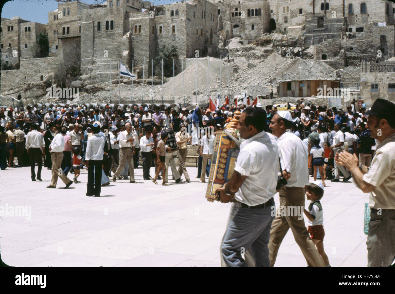 A photograph of individuals delivering Torah scrolls to the Wailing ...