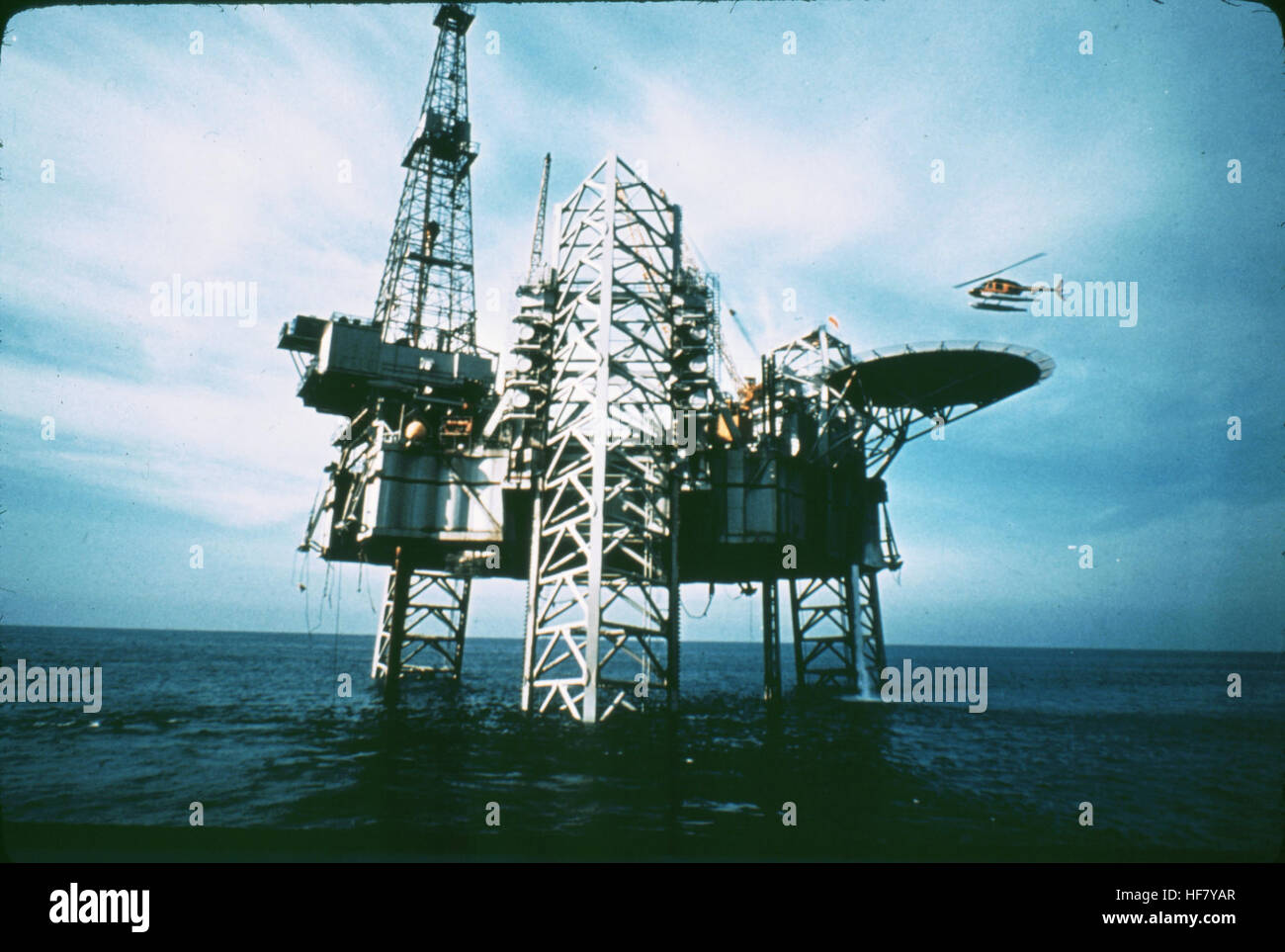 A photograph showing an oil drilling rig in Saudi Arabia, with a Bell ...