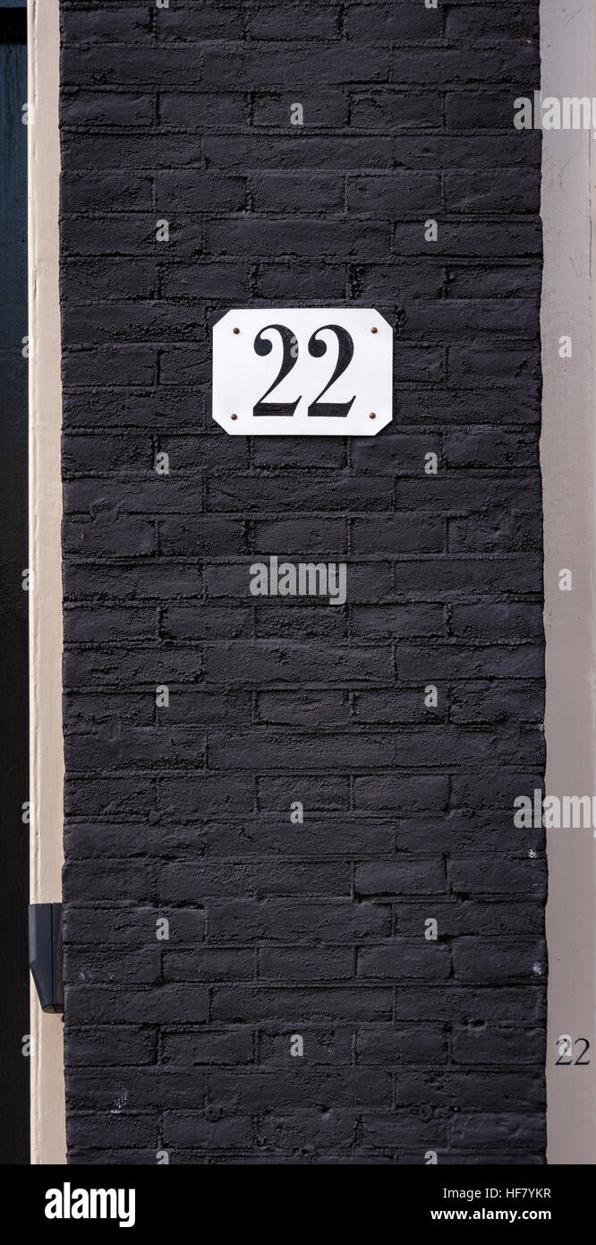 The house number 22 on a painted brick wall Stock Photo - Alamy