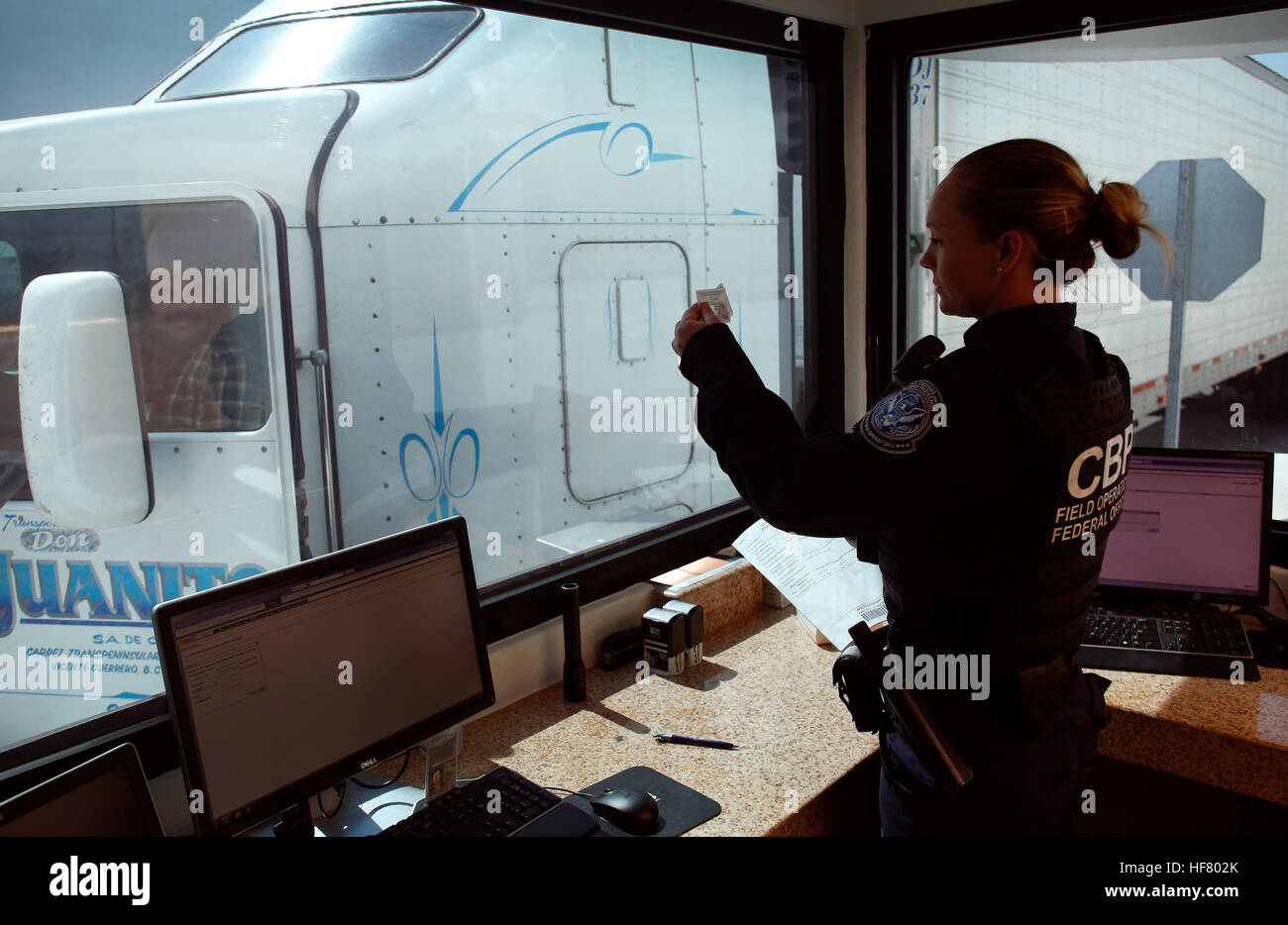 A U.S. Customs and Border Protection officer checks the identification ...