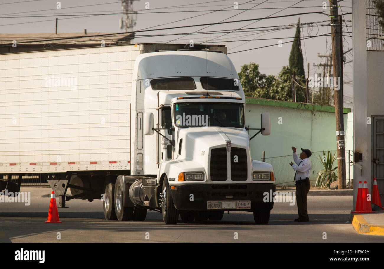 A truck is greeted by a Mexican security guard as it leaves Mesa de ...