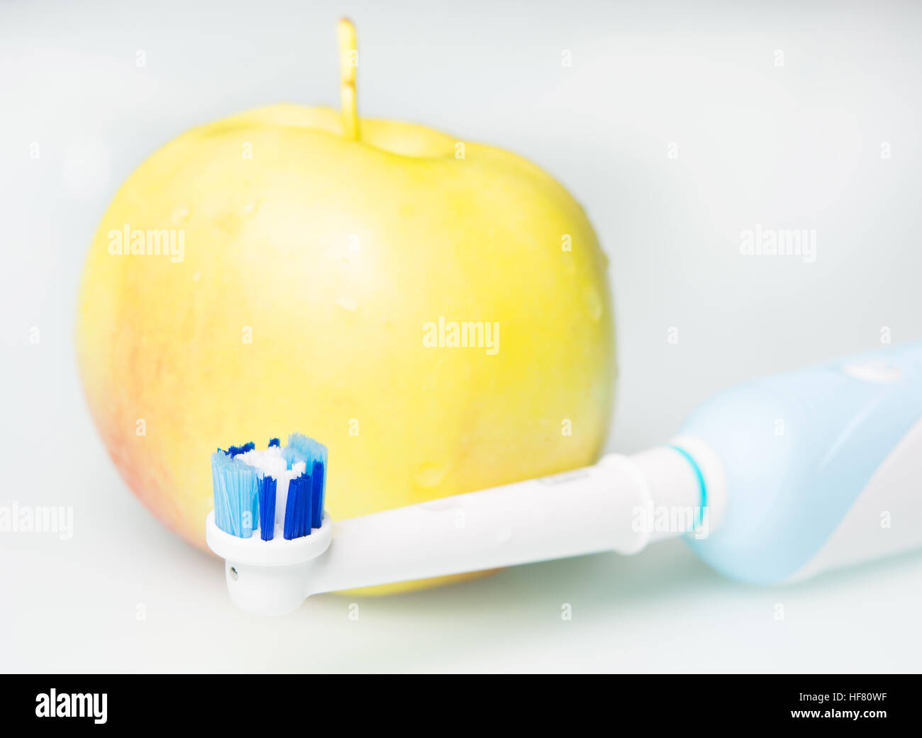 modern toothbrush next to the Apple Stock Photo - Alamy