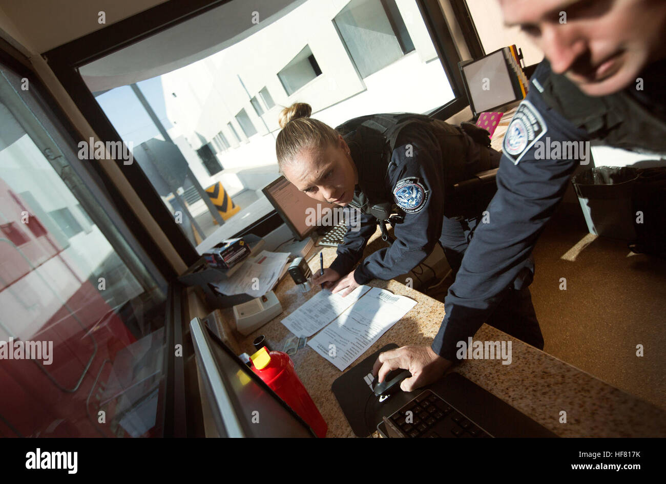 U.S. Customs and Border Protection officers check the credentials of ...