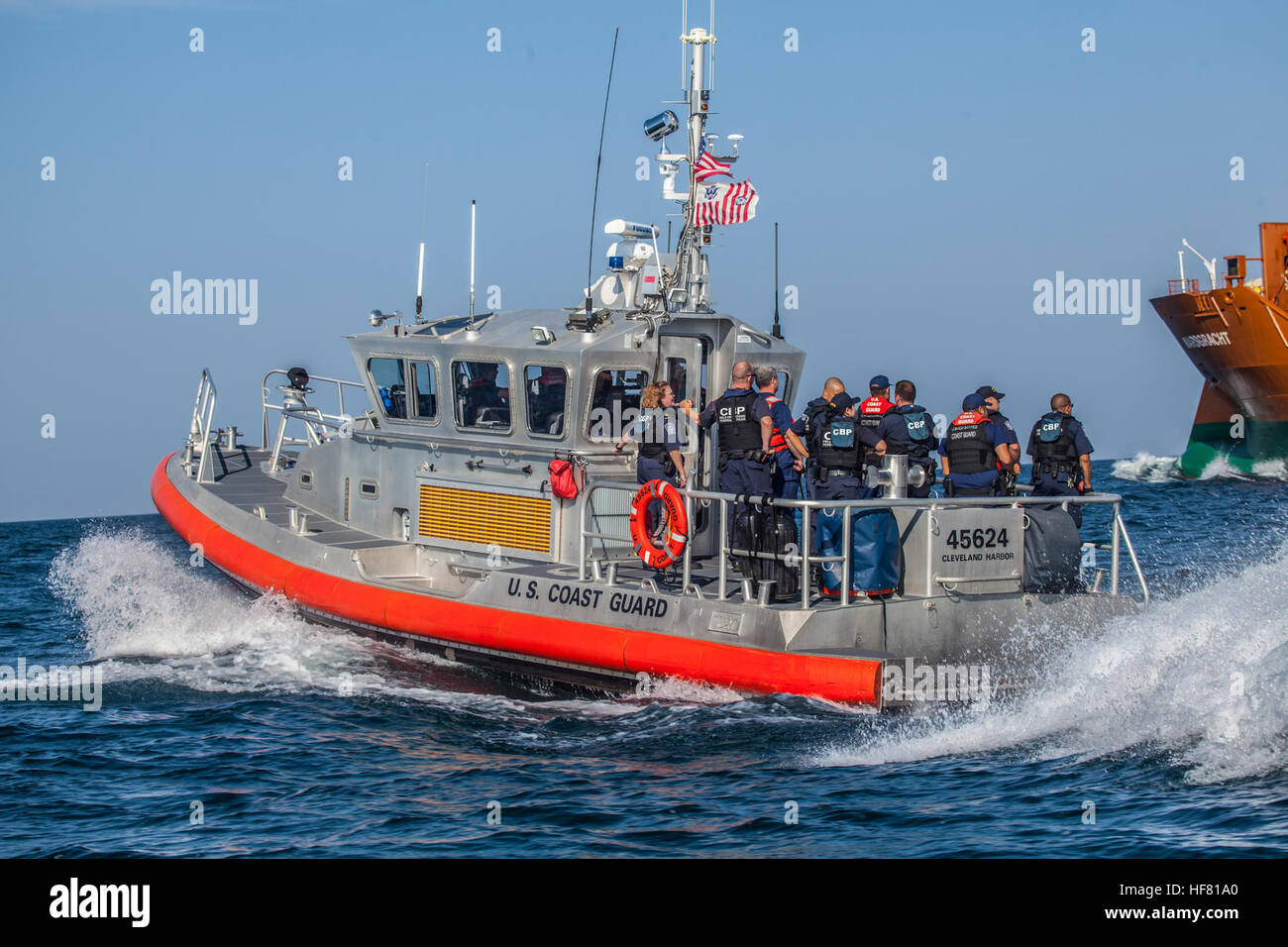 A USCG vessel transports a joint CBP and USCG team to clear a vessel ...