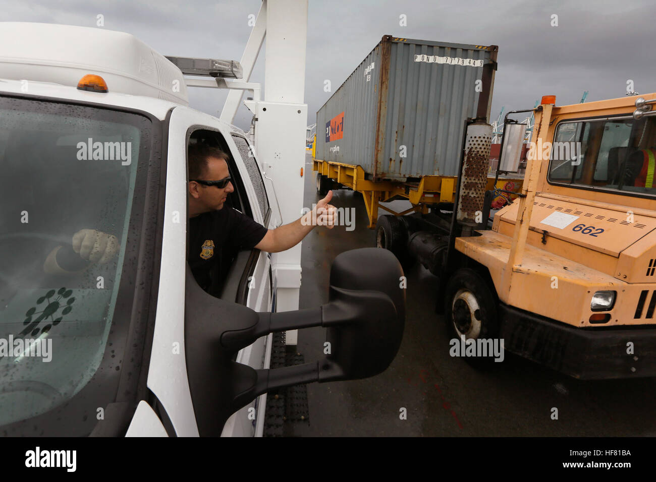 A U.S. Customs and Border Protection officer gives the thumbs-up to the ...