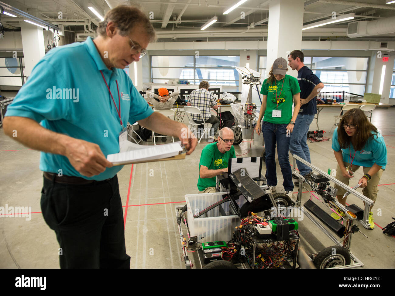 Judges inspect the robot from team Sirius during the 2016 Sample Return ...