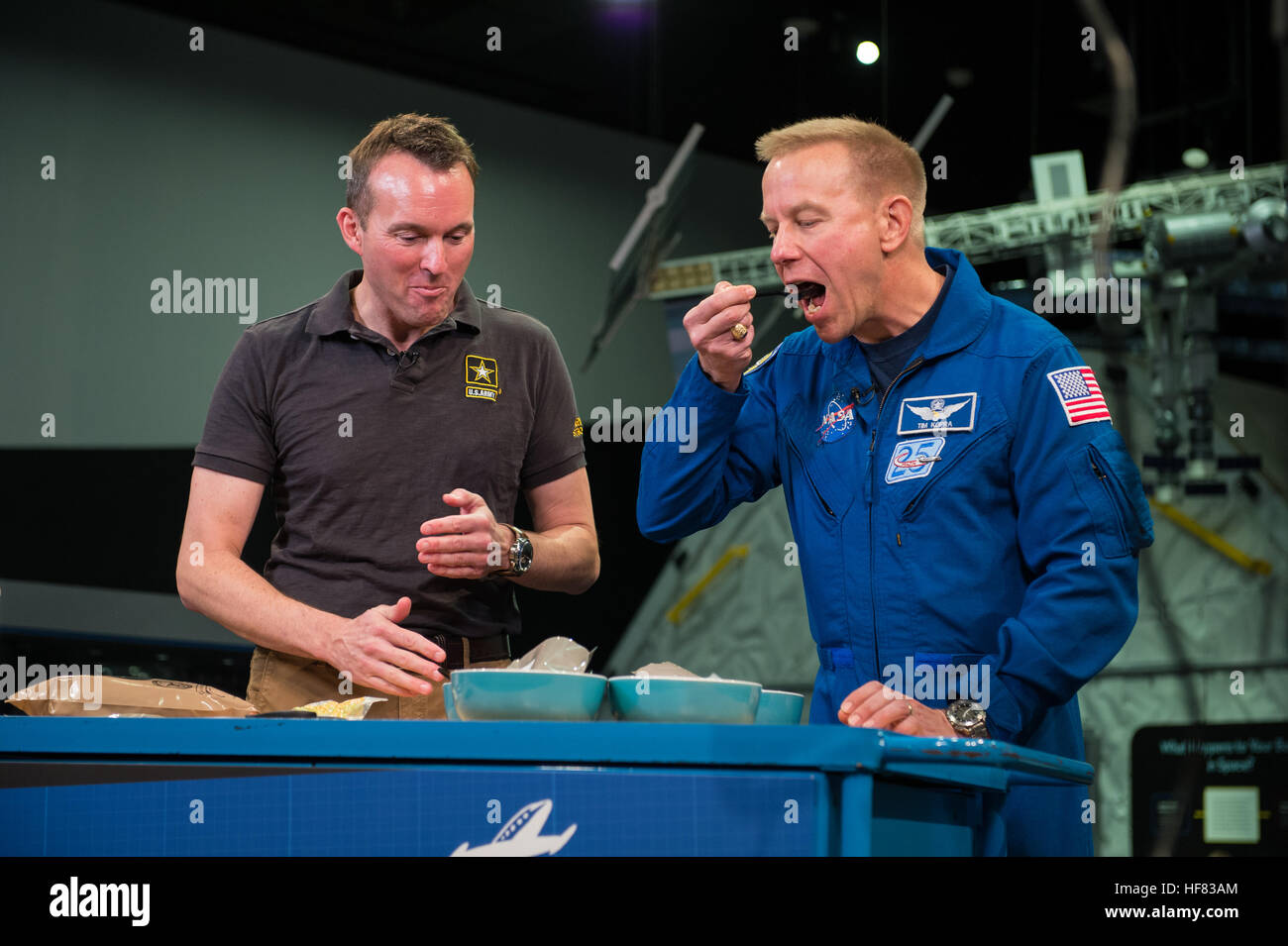 NASA astronaut Tim Kopra, right, takes a bite of some space food during ...