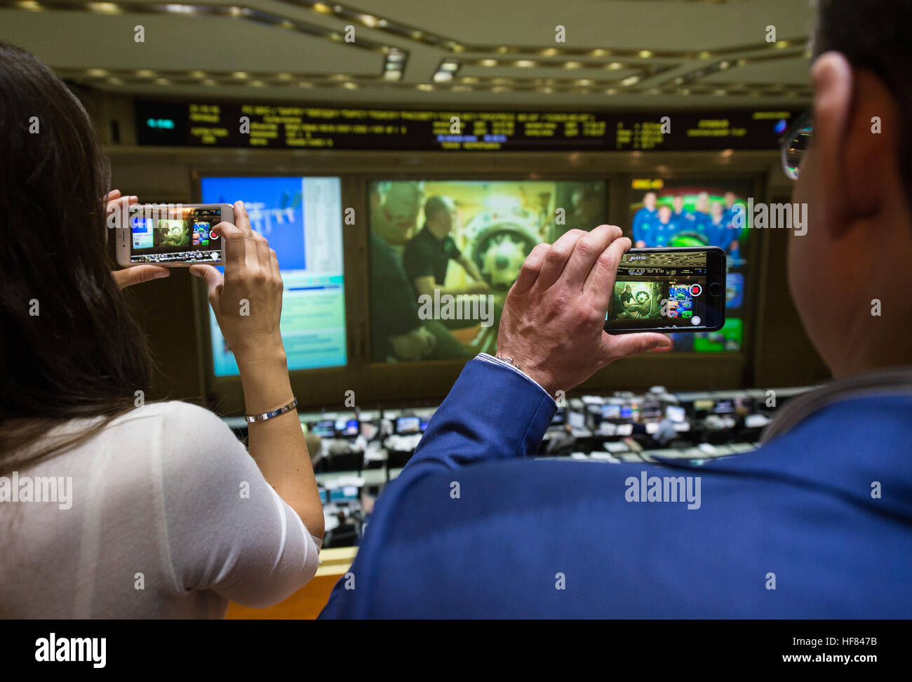Guests record the opening of the hatch between the Soyuz MS-02 ...
