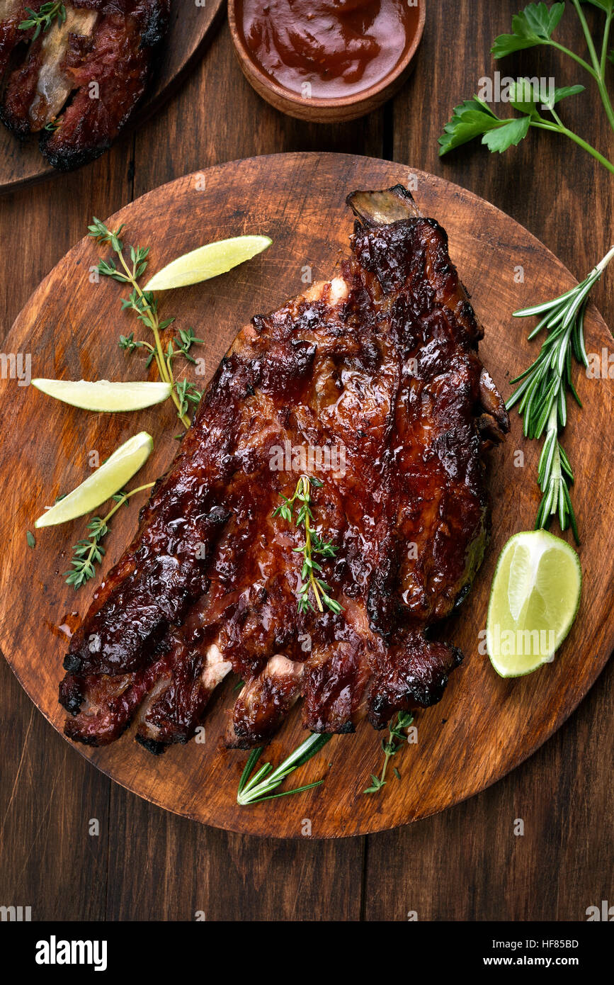 Barbecue pork ribs on wooden board, top view Stock Photo - Alamy