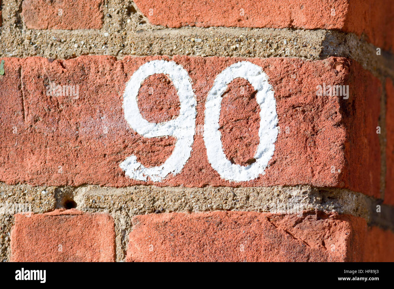 House number 90 sign painted on wall Stock Photo - Alamy