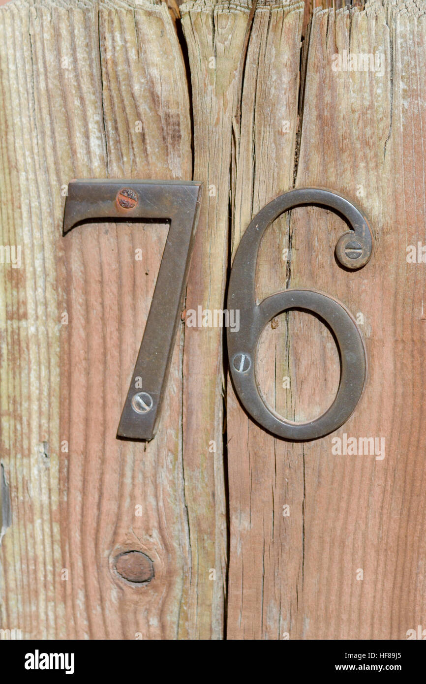 House number 76 sign on gate Stock Photo - Alamy