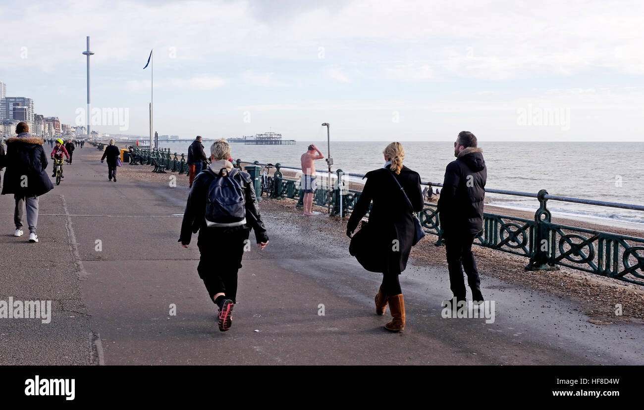 People walk along the promenade in brighton hi-res stock photography ...
