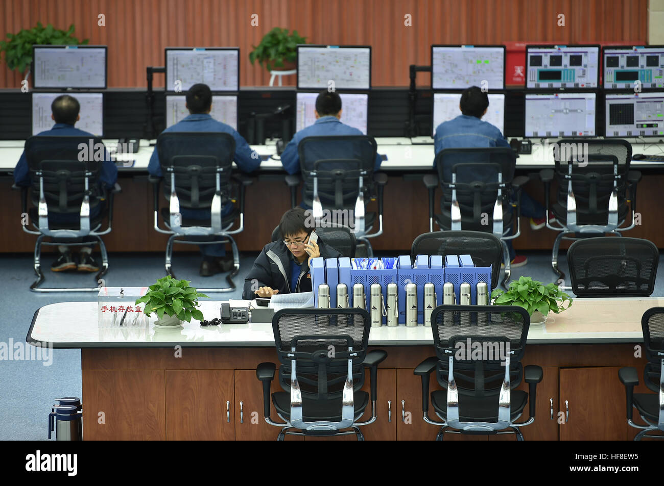 Yinchuan. 28th Dec, 2016. Staff members work at the central control ...