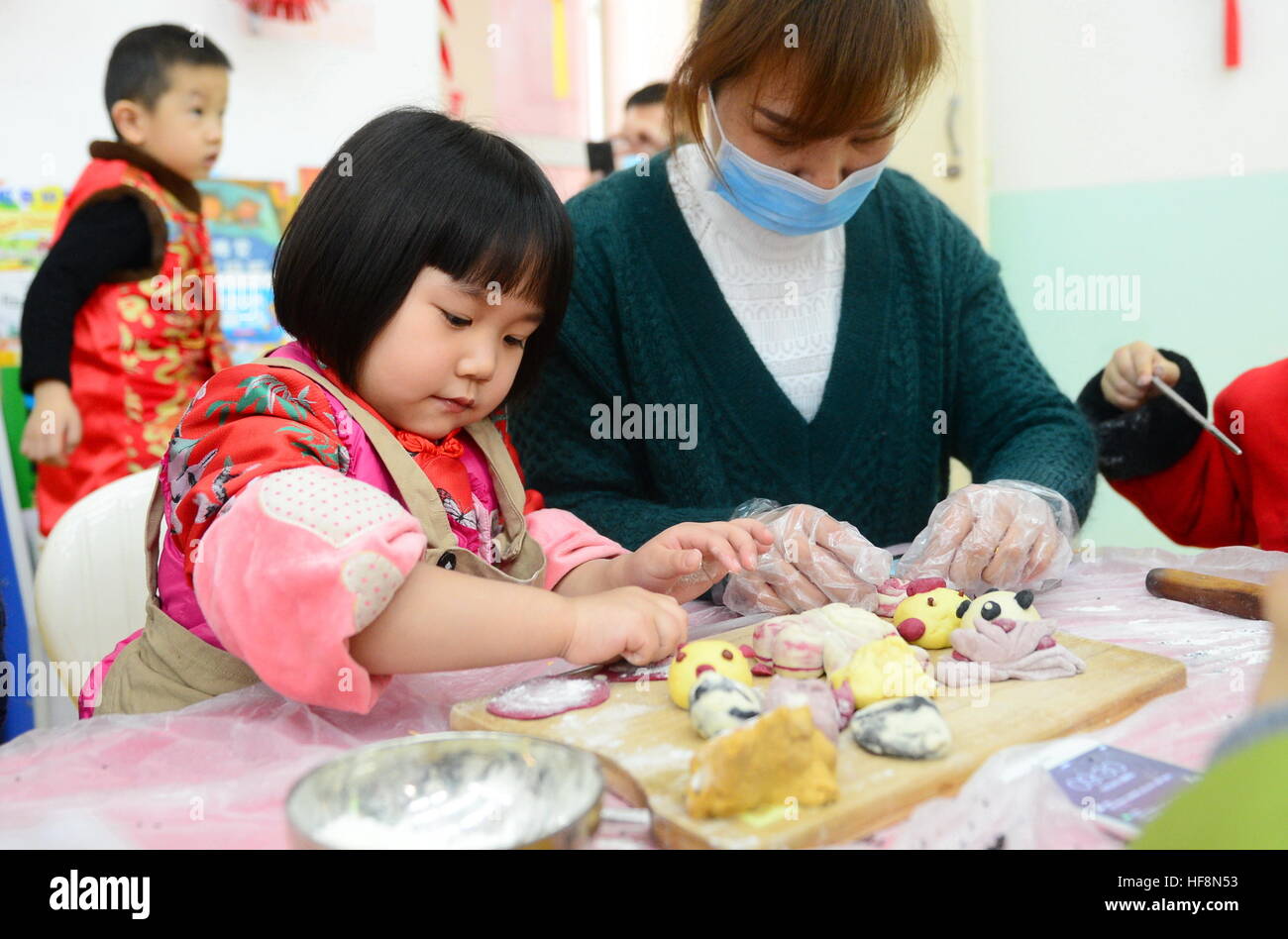Shijiazhuang. 30th Dec, 2016. A girl makes animal-shaped steamed buns ...