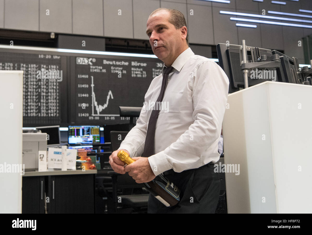 A stockbroker opens a bottle of prosecco in the trading room of the ...