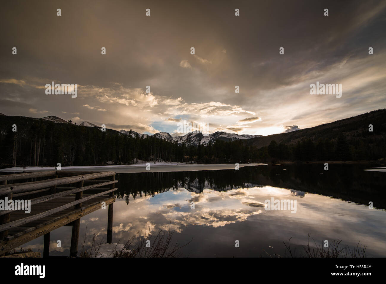 A dock looking out on a reflective pond Stock Photo - Alamy