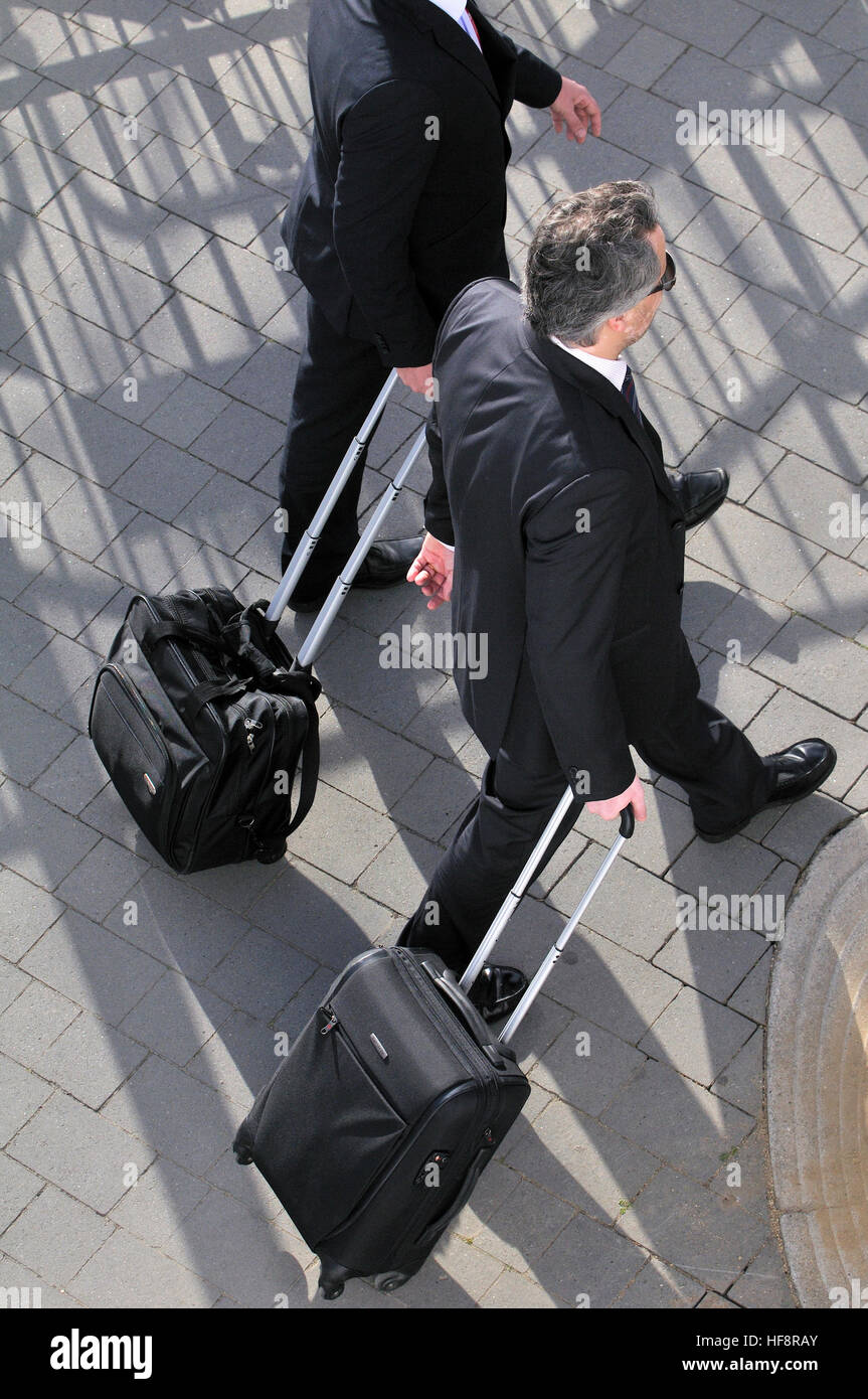 Business men with trolley Stock Photo - Alamy