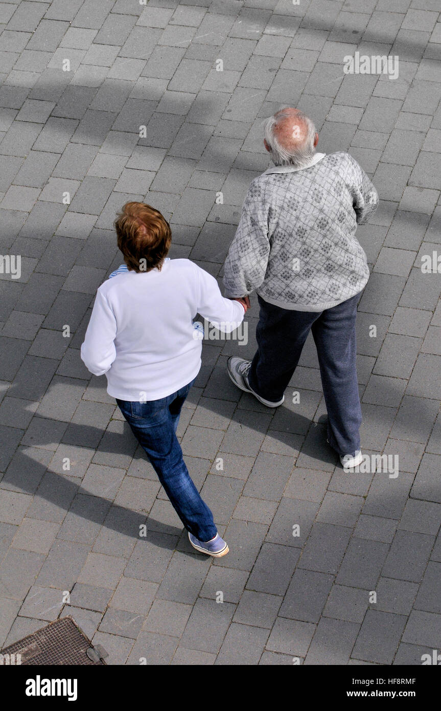 People walking with holding hands Stock Photo - Alamy