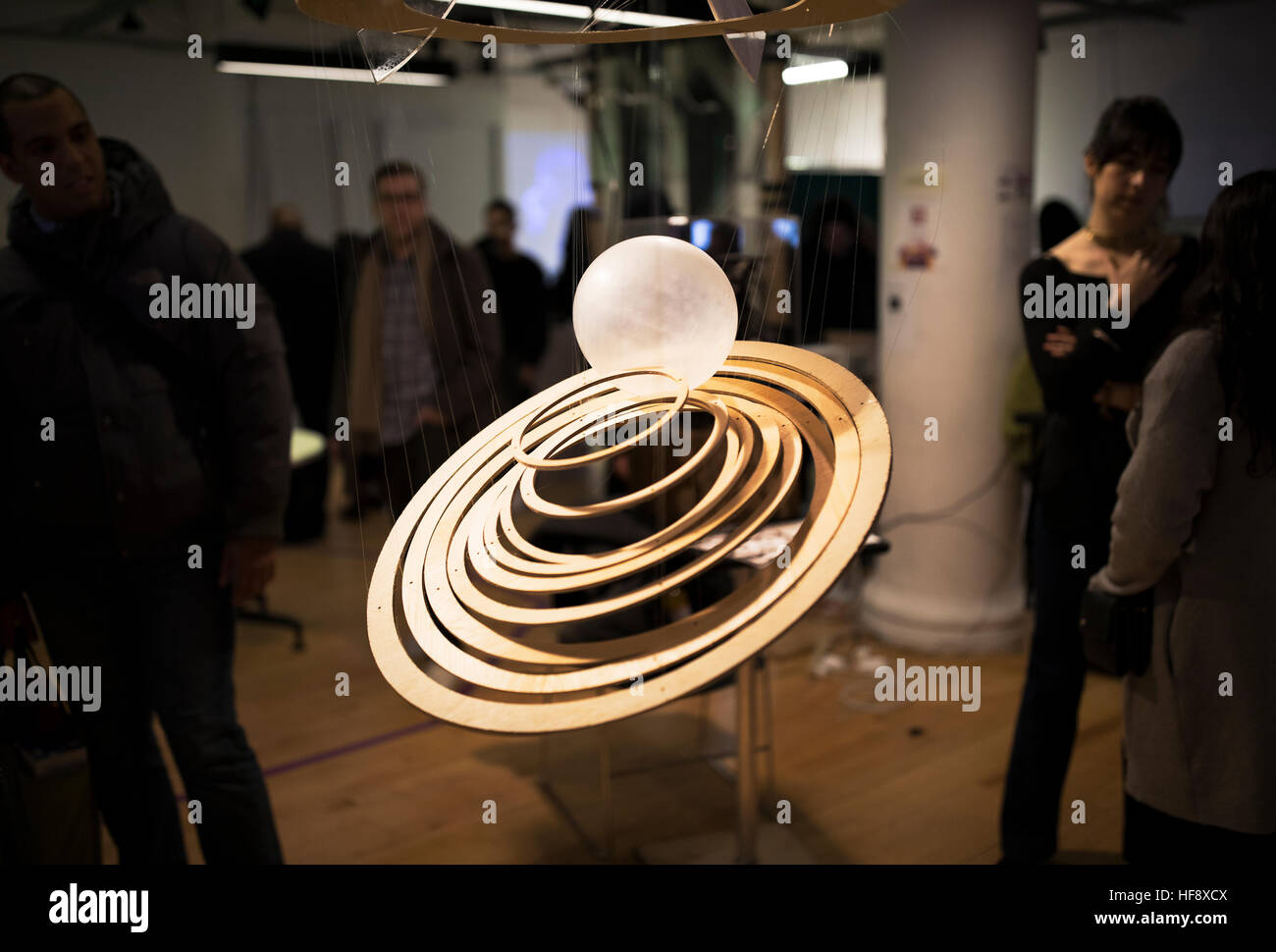 A crowd watch a series of moving concentric wooden circles during the ...