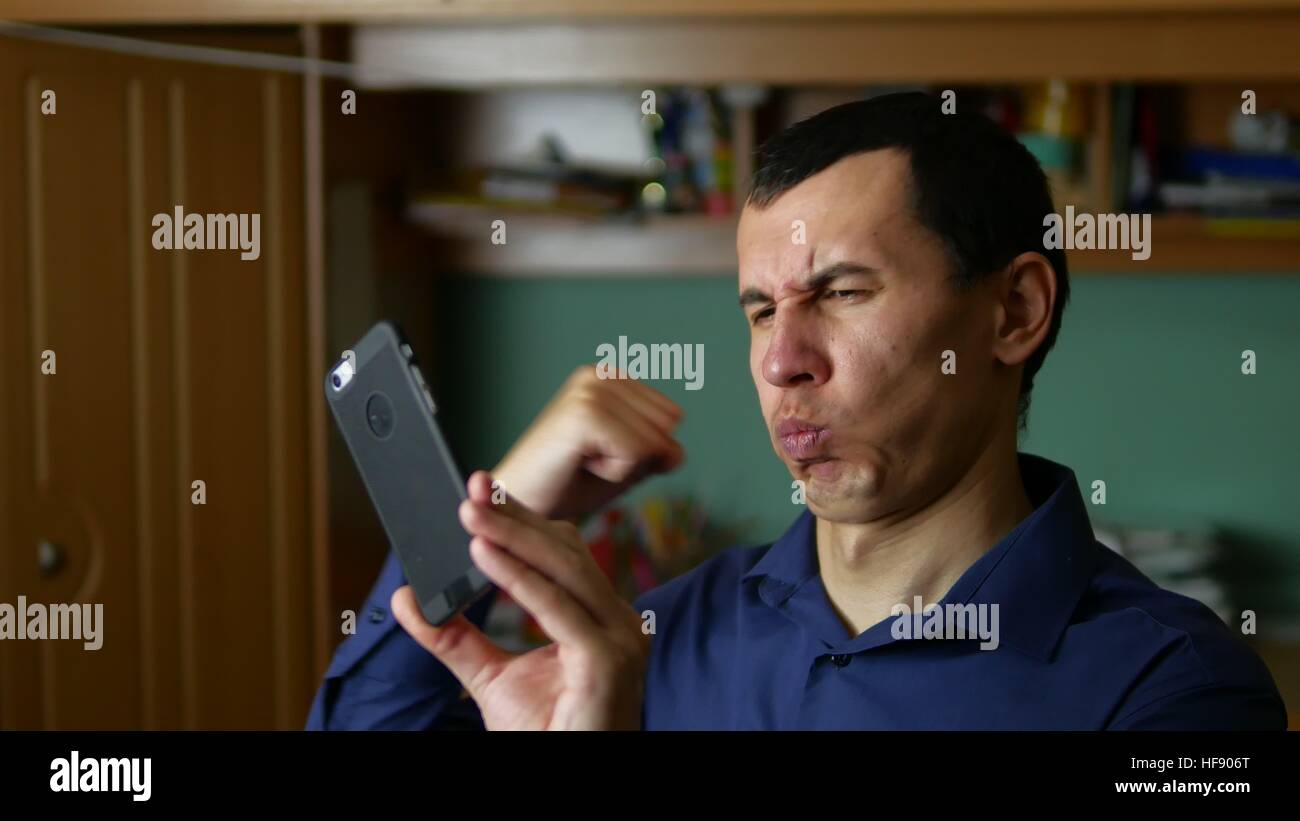 man makes a funny selfie phone smartphone indoor Stock Photo - Alamy