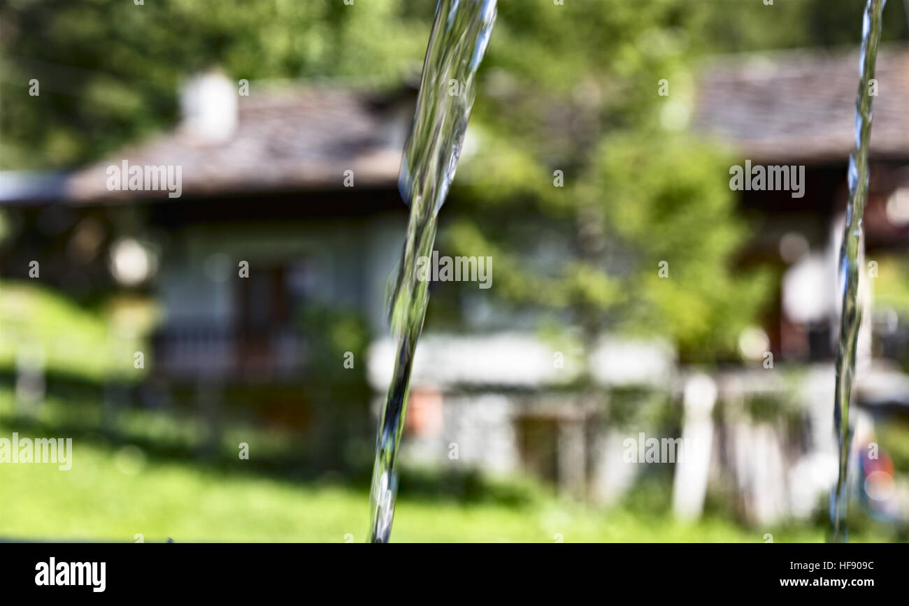 Two jets of water spouting from a fountain in a close up selective ...
