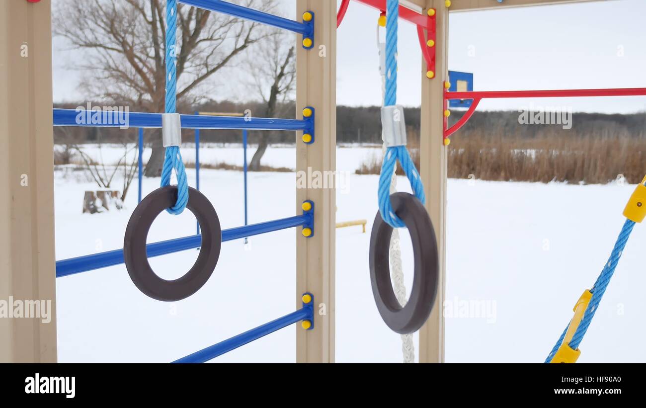 children playground gymnastic rings swing, winter snow landscape Stock ...