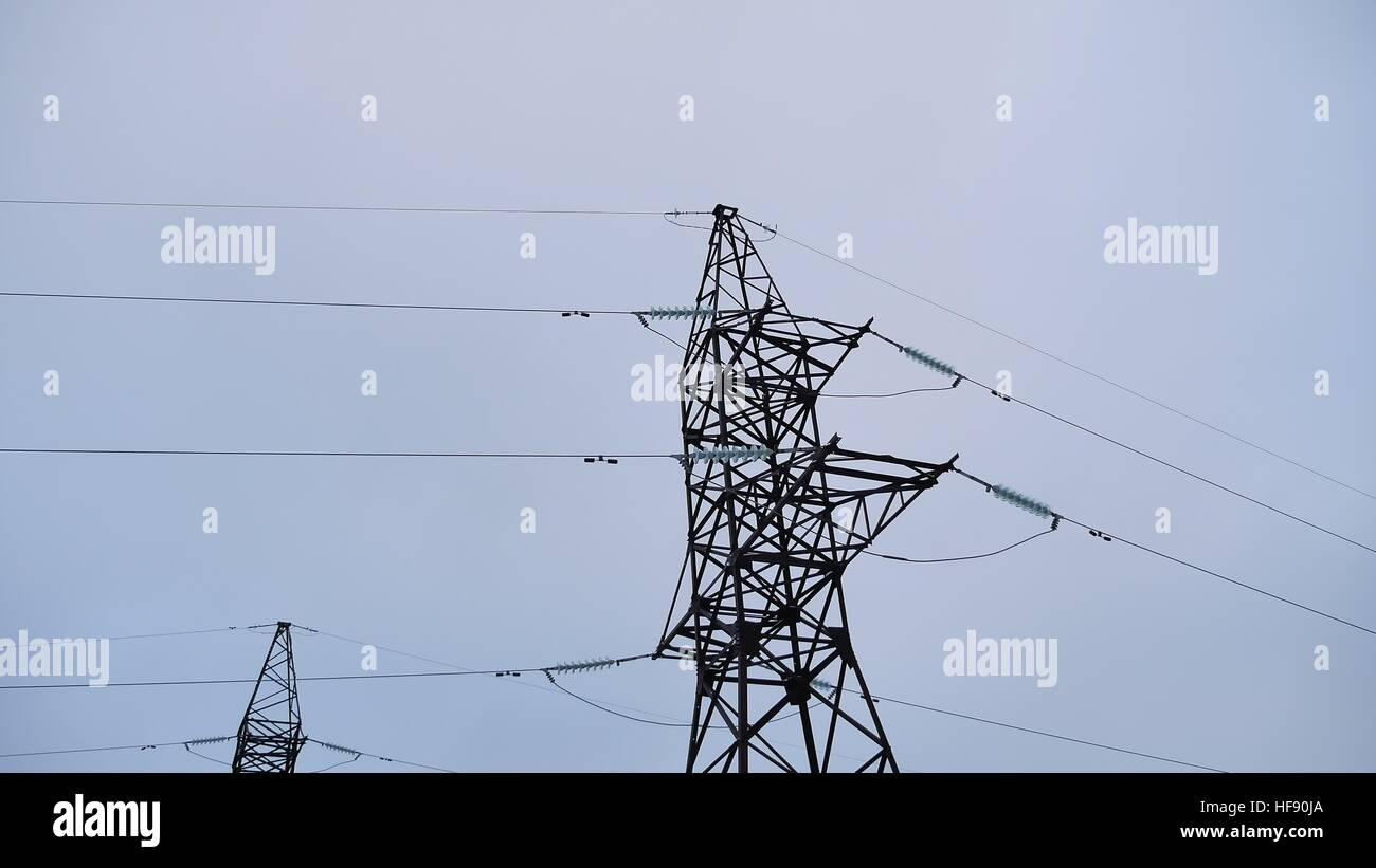 Electrical tower with cables against the gray electricity background ...