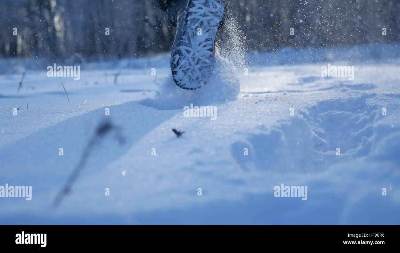 man running in the snow legs in shoes field and forest beautiful winter ...